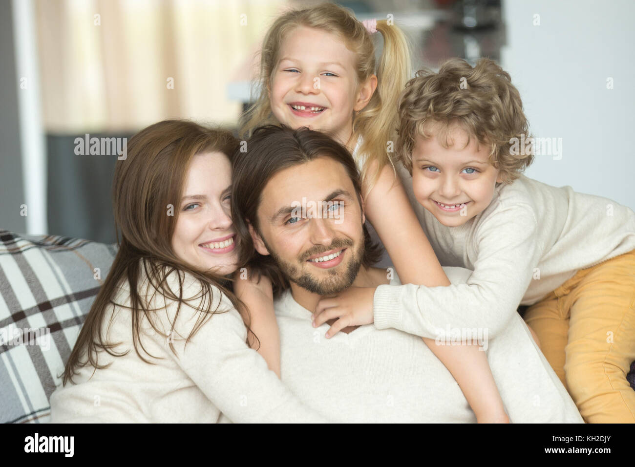 Portrait of happy cheerful young family bonding together, smiling kids ...