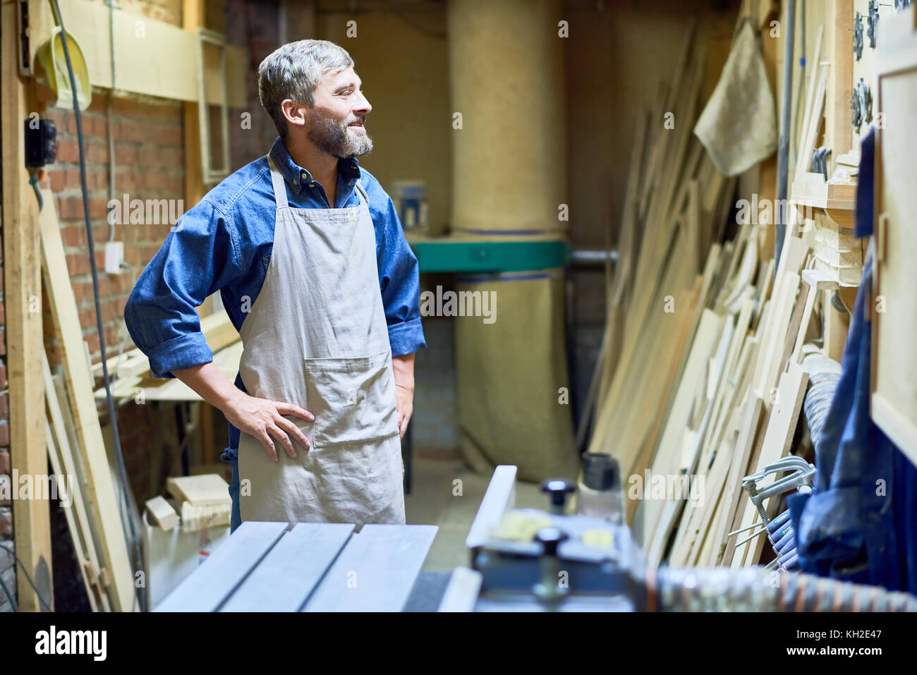 Bearded craftsman inspecting wood in hi-res stock photography and ...