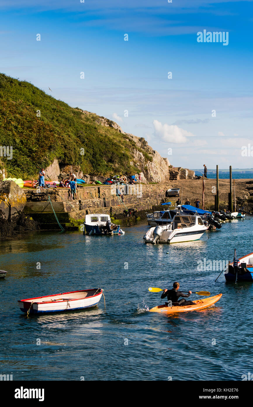 People rowing and kayaking in Porthclais harbour , near Ty Ddewi / St ...