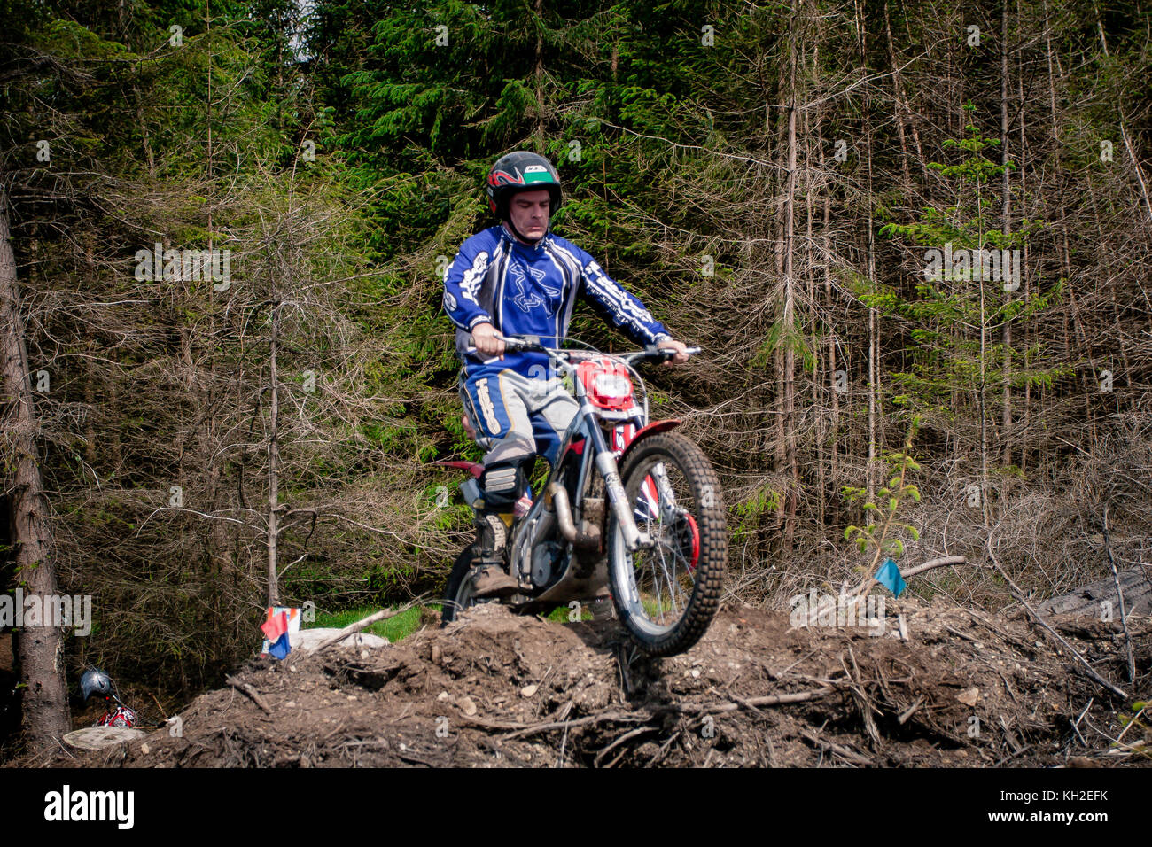 Motorcross bike rider on a cross trail showing of skills on a difficult ...