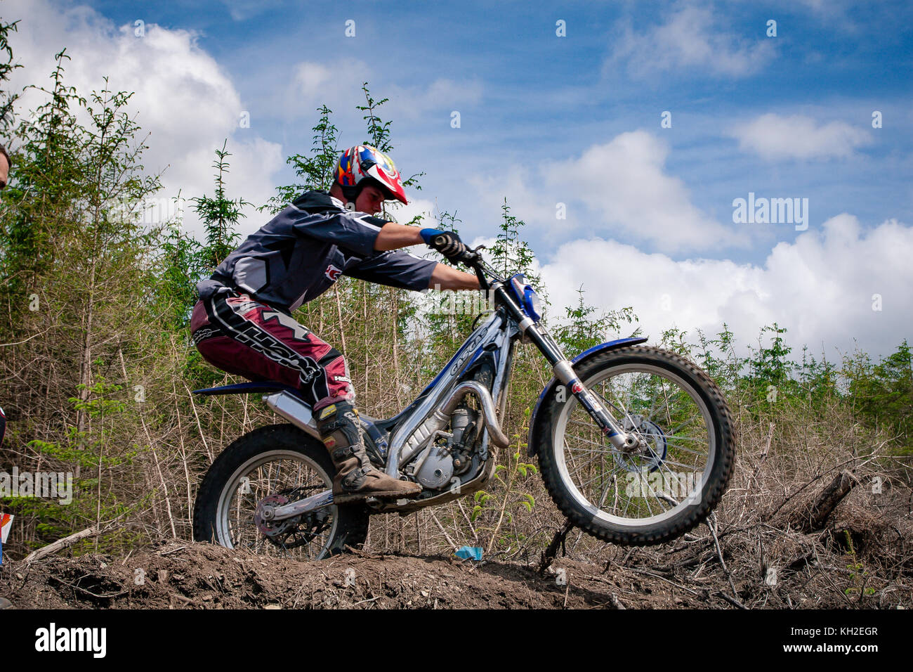 Motorcross bike rider on a cross trail showing of skills on a difficult ...