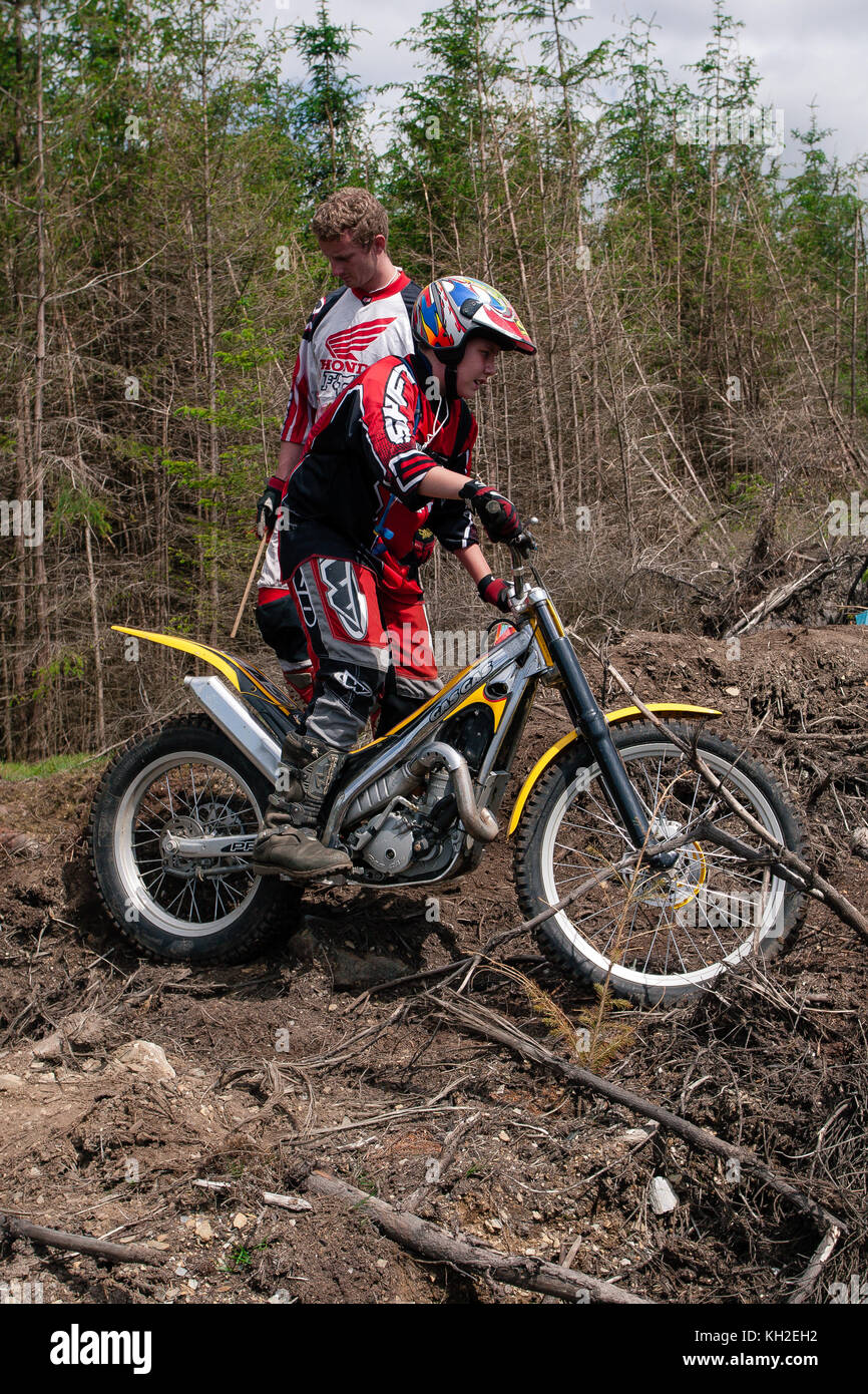 Motorcross bike rider on a cross trail showing of skills on a difficult ...