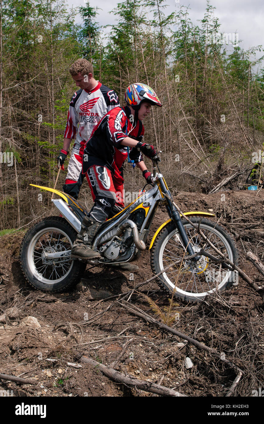 Motorcross bike rider on a cross trail showing of skills on a difficult ...