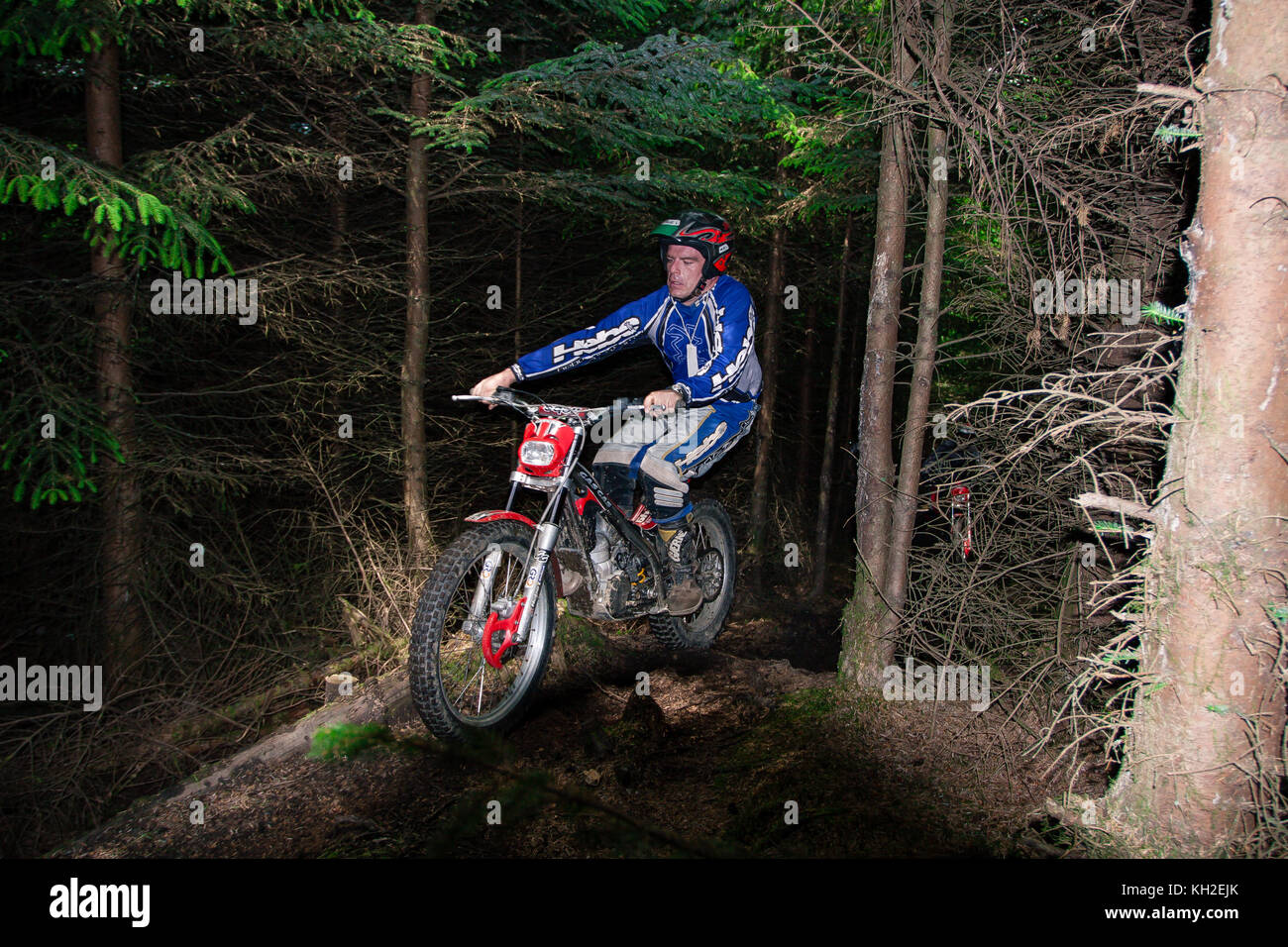 Motorcross bike rider on a cross trail showing of skills on a difficult ...