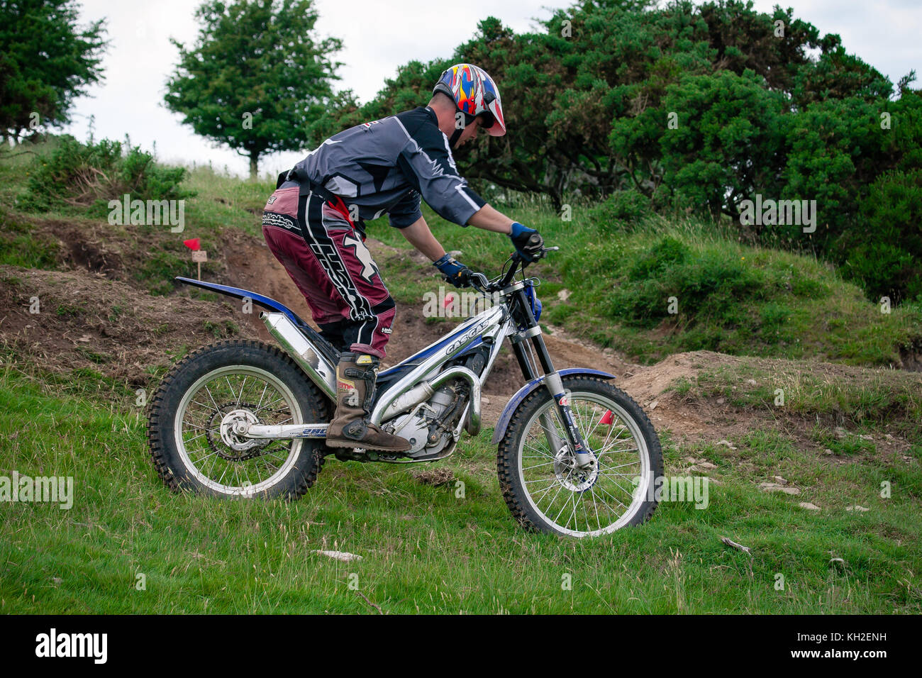 Motorcross bike rider on a cross trail following designated track on a ...