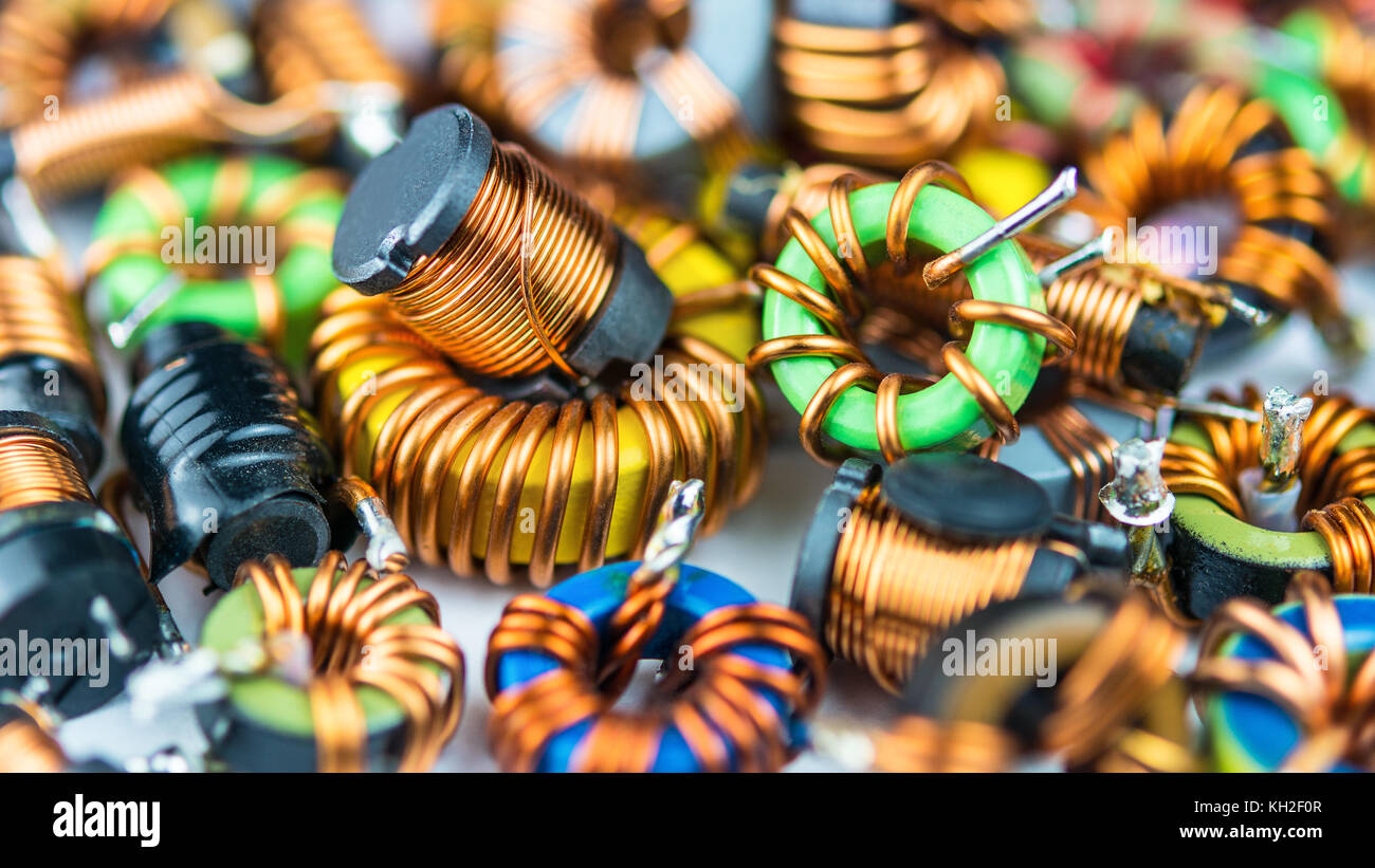 Colorful coils with magnetic core and copper winding. Background from ...
