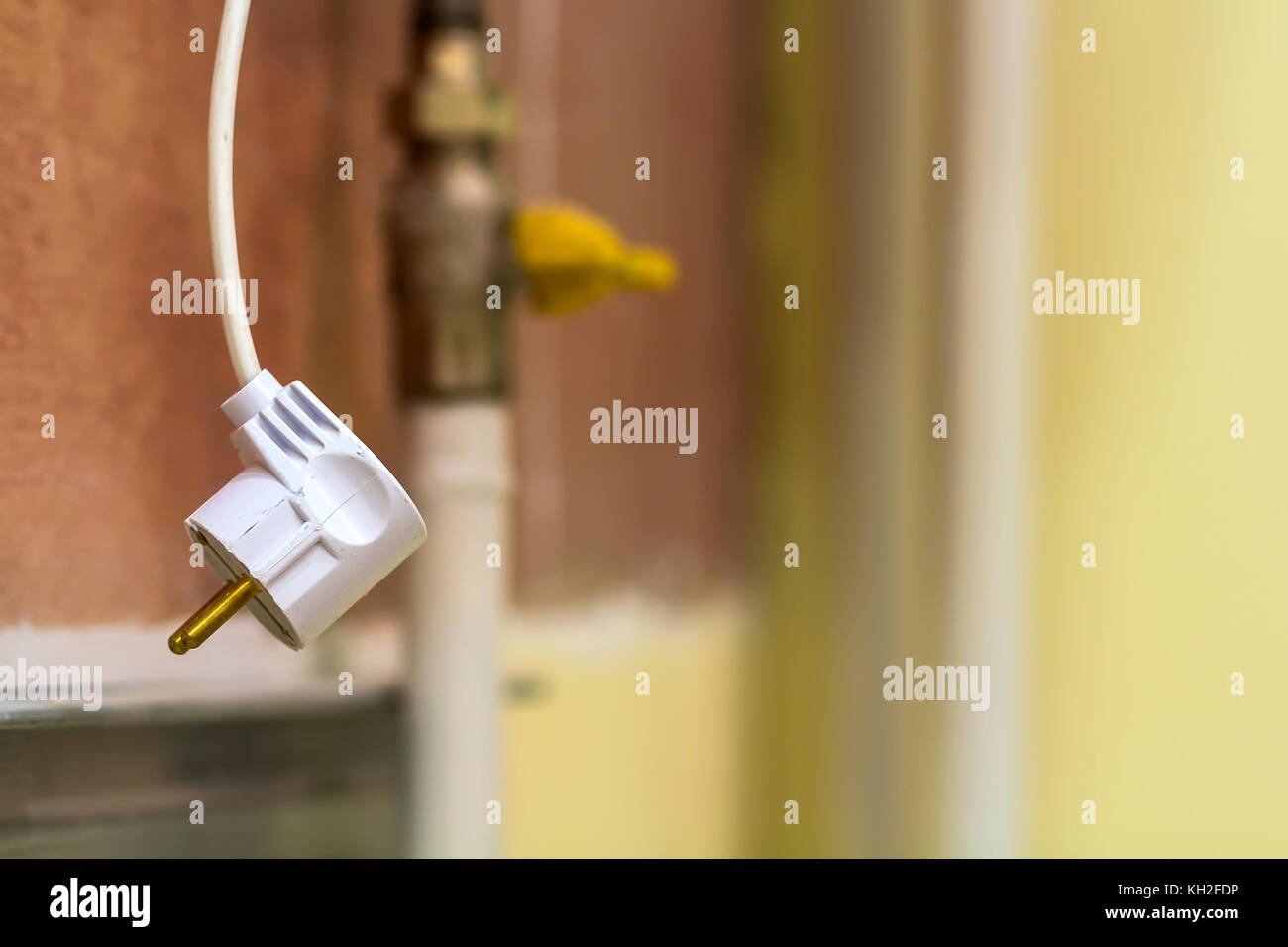 White electric plug cable isolated on blurred background Stock Photo ...