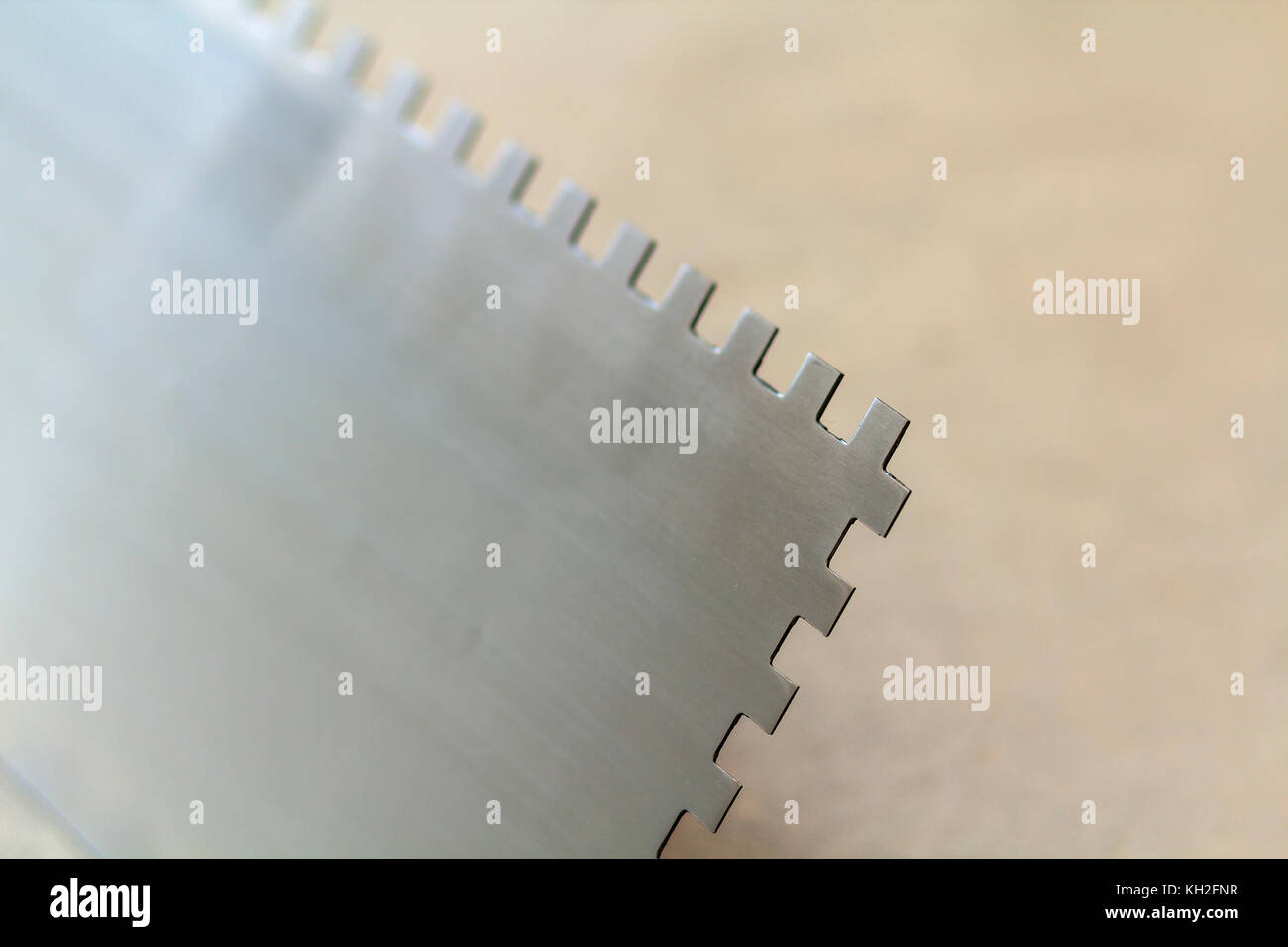 Construction notched trowel is a tool for tiles installation work Stock ...