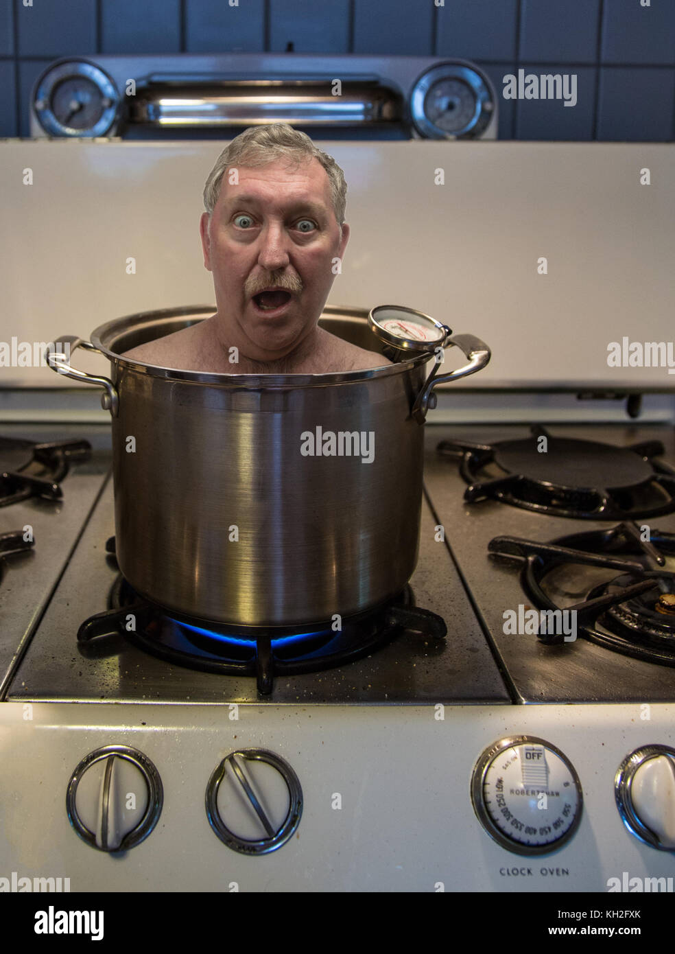 Man's head shown in pot of boiling water on stove. Studio image. Apr 23 ...