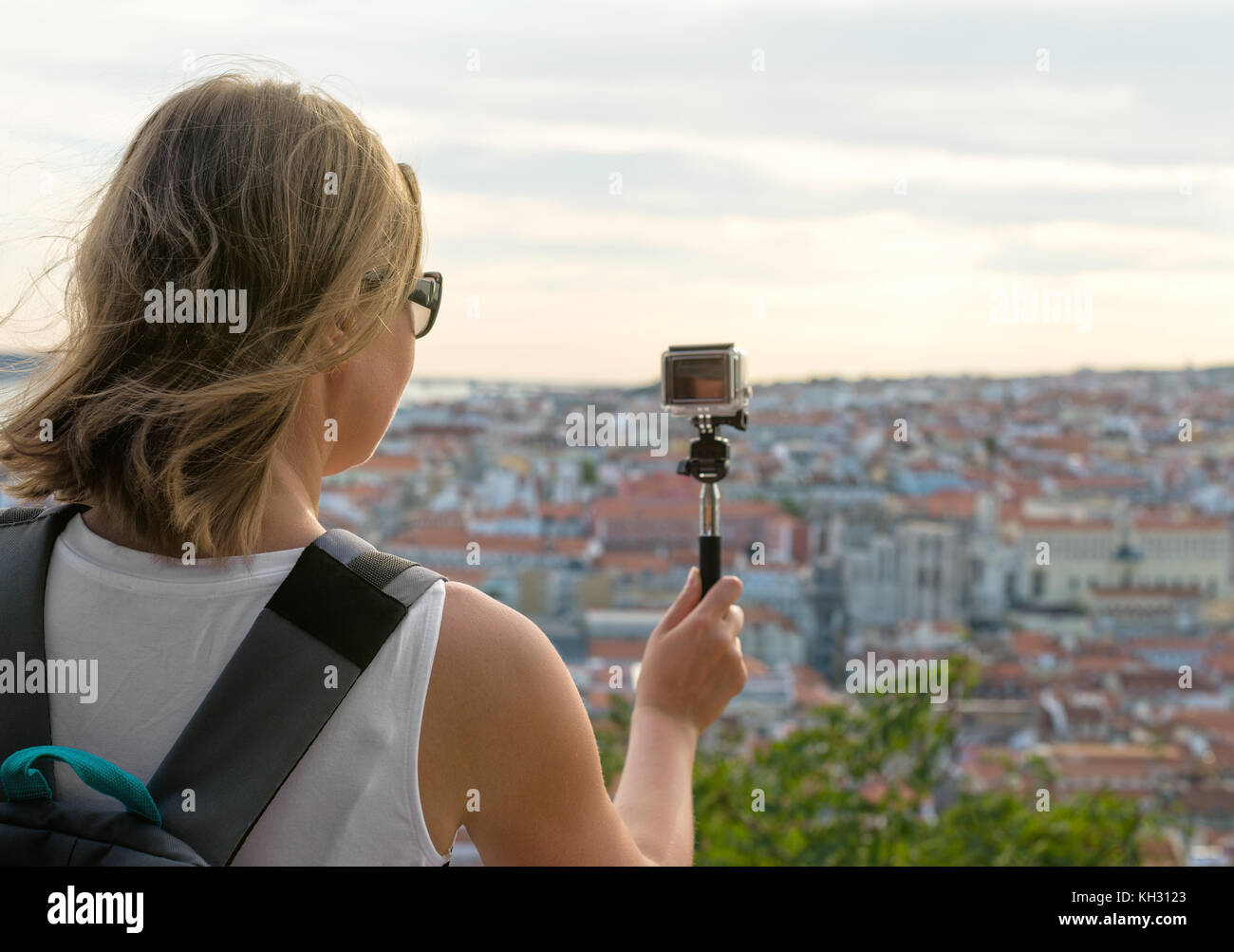 Woman traveller with camera shooting video Stock Photo - Alamy
