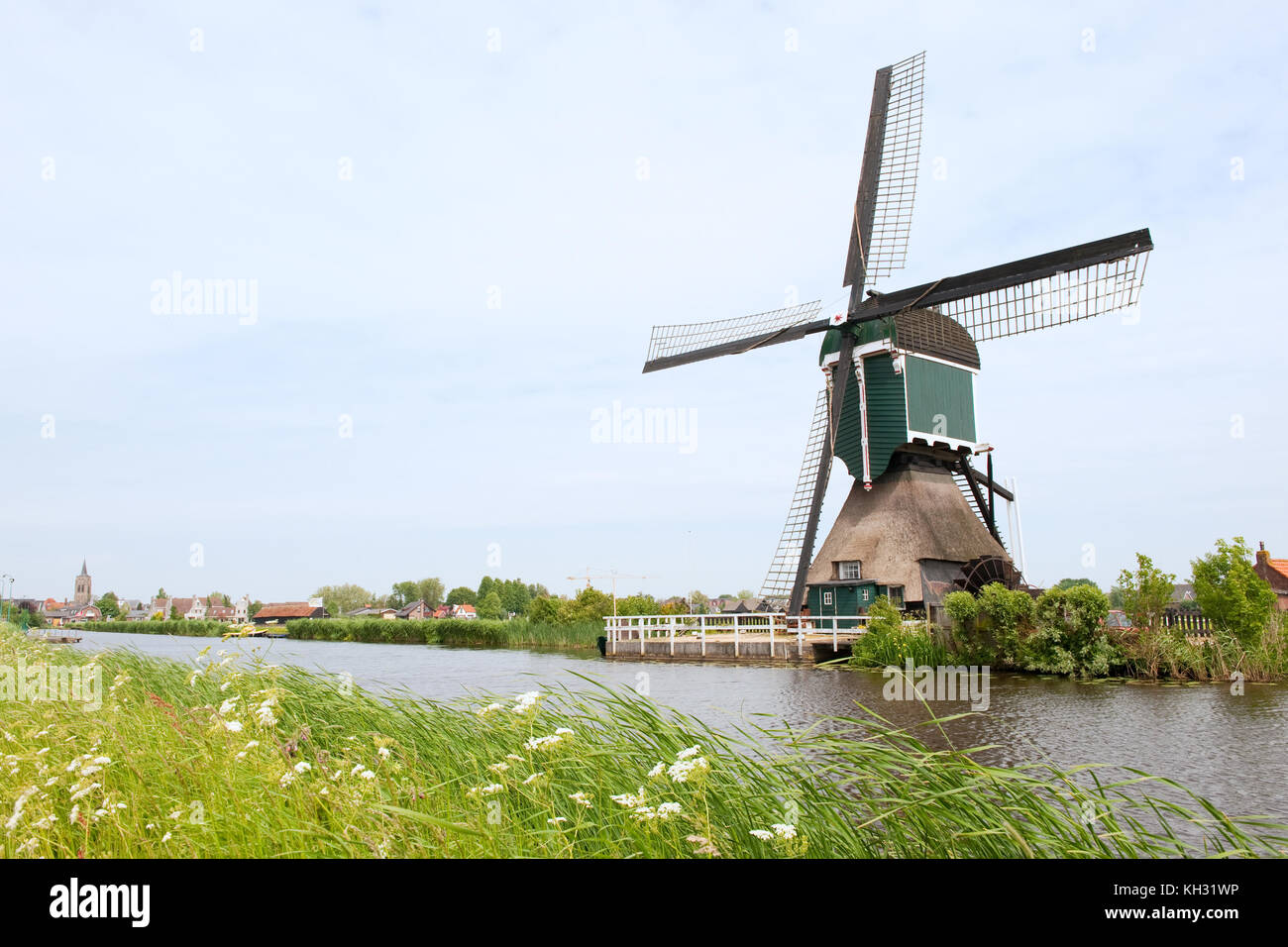 Dutch windmill in typical Hollands landscape near the river Stock Photo ...