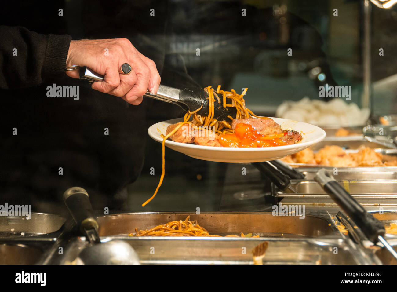 Customers helping themselves to food in a self service Chinese ...