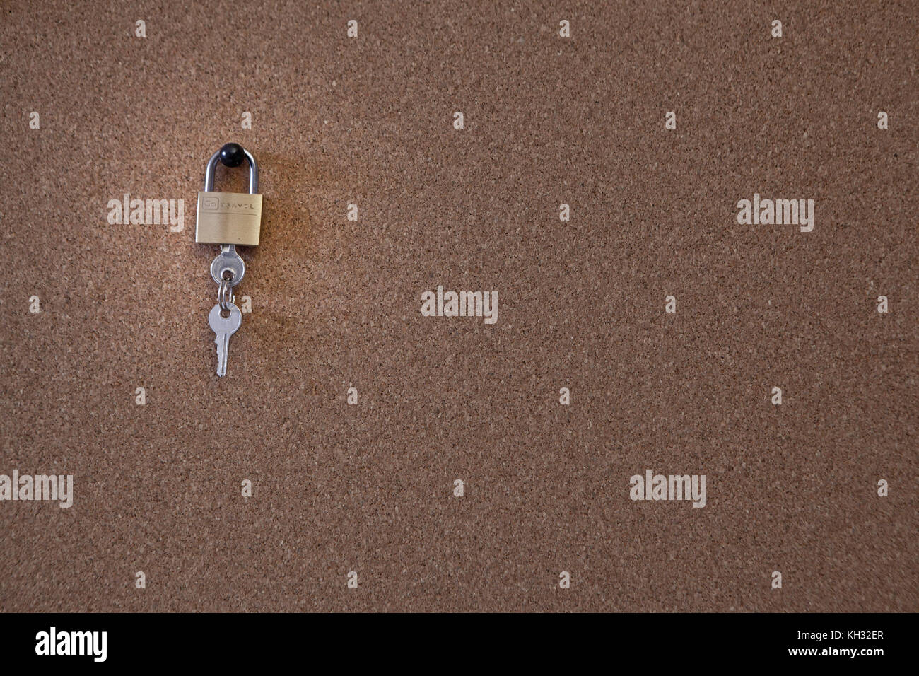 lock hanging on cork board Stock Photo - Alamy