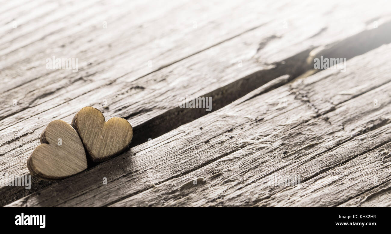 Two small hearts on old wood background Stock Photo - Alamy