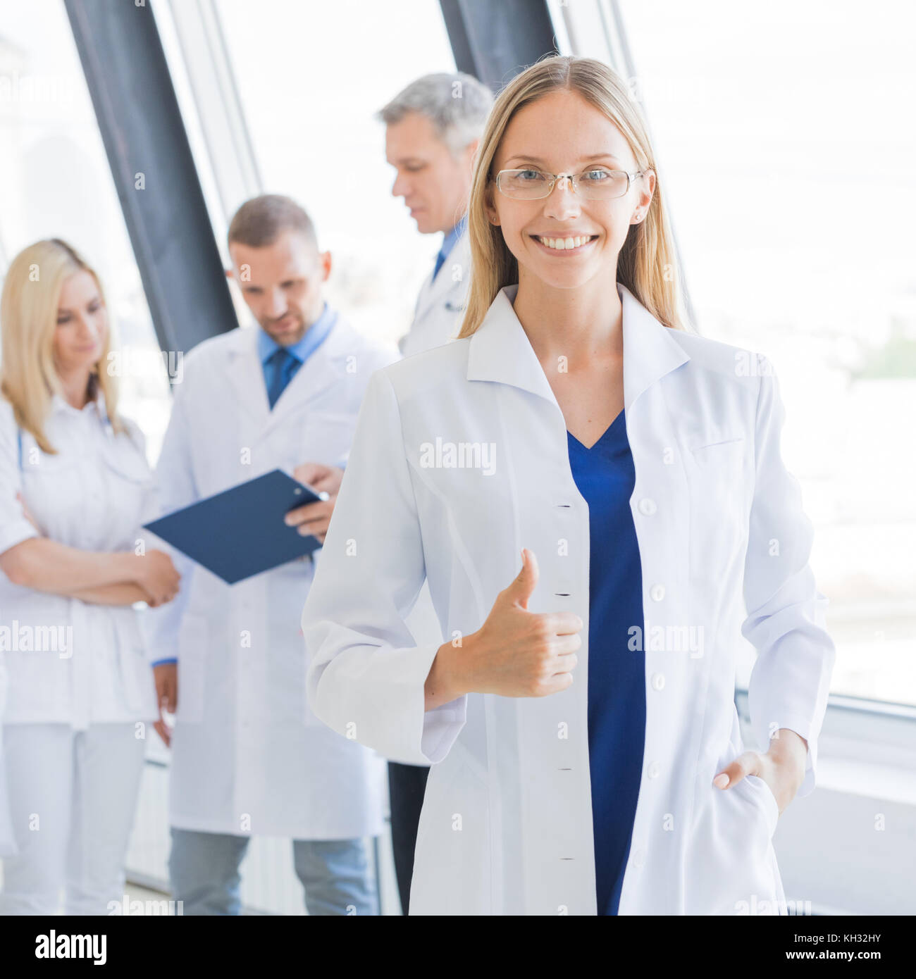 Young female doctor and medical team in hospital Stock Photo - Alamy