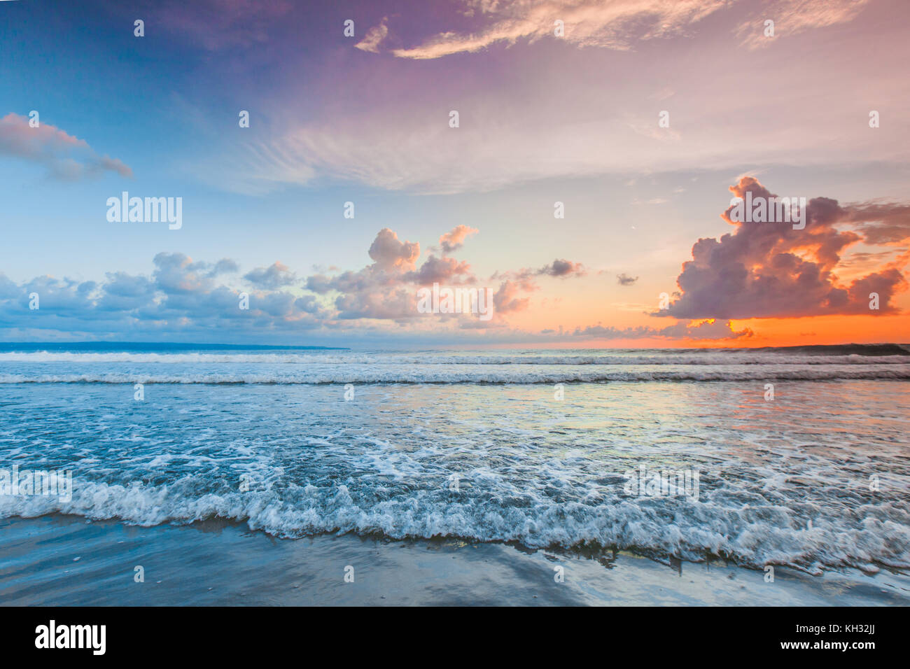 Splashing ocean wave in front of beautiful sunset sky background Stock ...