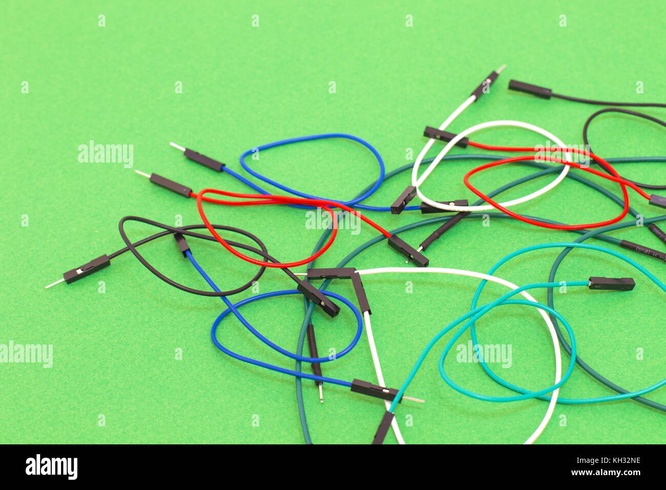 Set of colorful cables on green background Stock Photo - Alamy