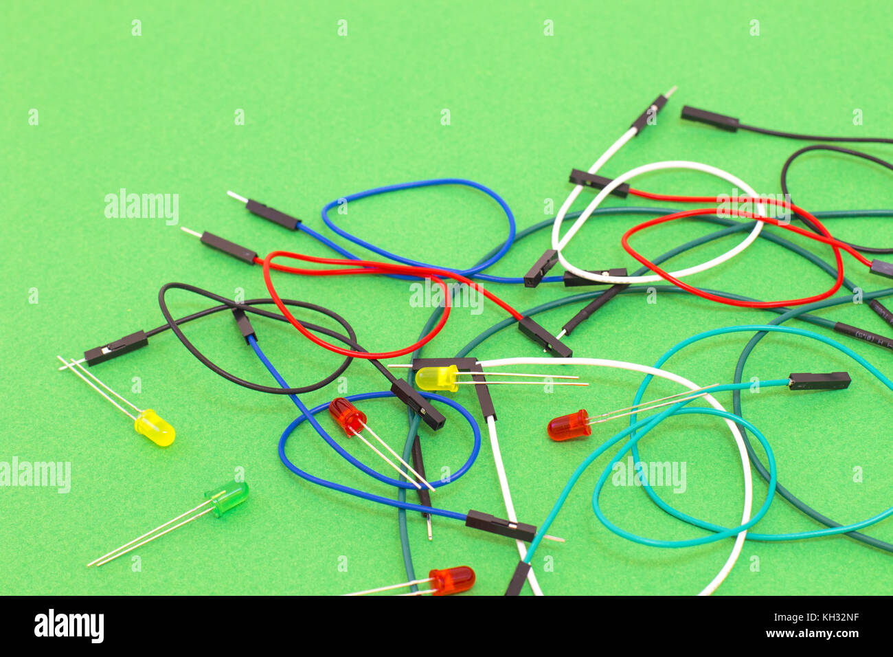 Set of colorful cables and diode on green background Stock Photo - Alamy