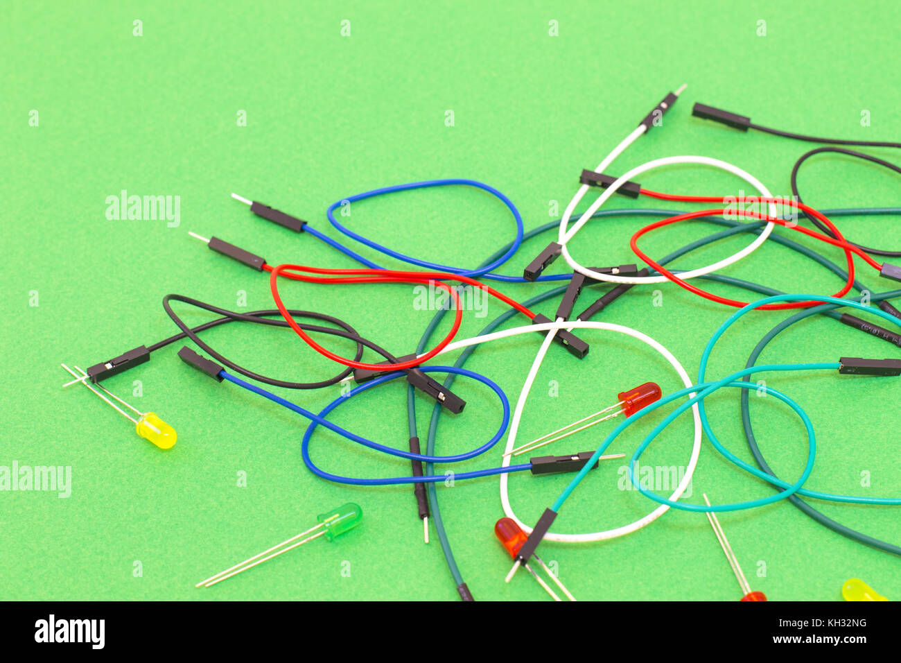 Set of colorful cables and diode on green background Stock Photo - Alamy