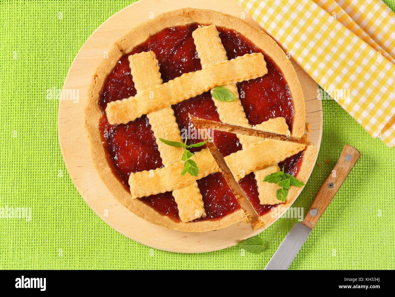strawberry jam tart with lattice on top on wooden cutting board Stock ...