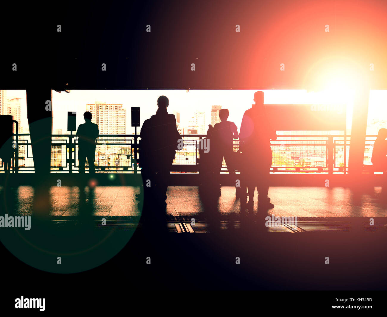 Silhouette of people waiting at train's platform with backlight Stock ...