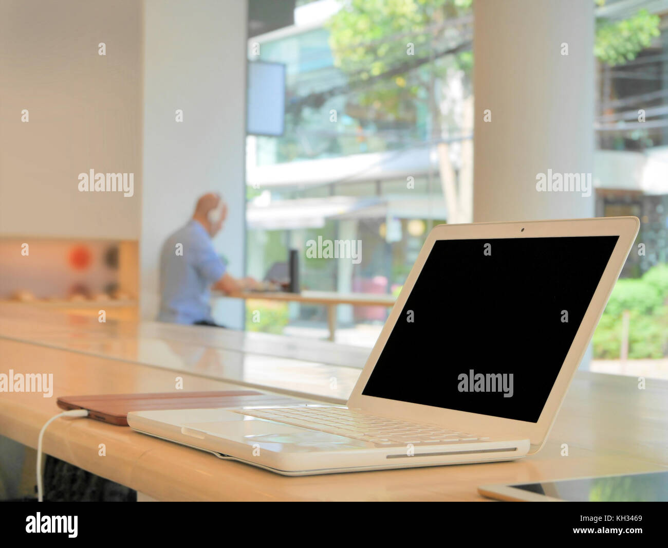 Environment at a coffee shop with male customer working on computer and ...