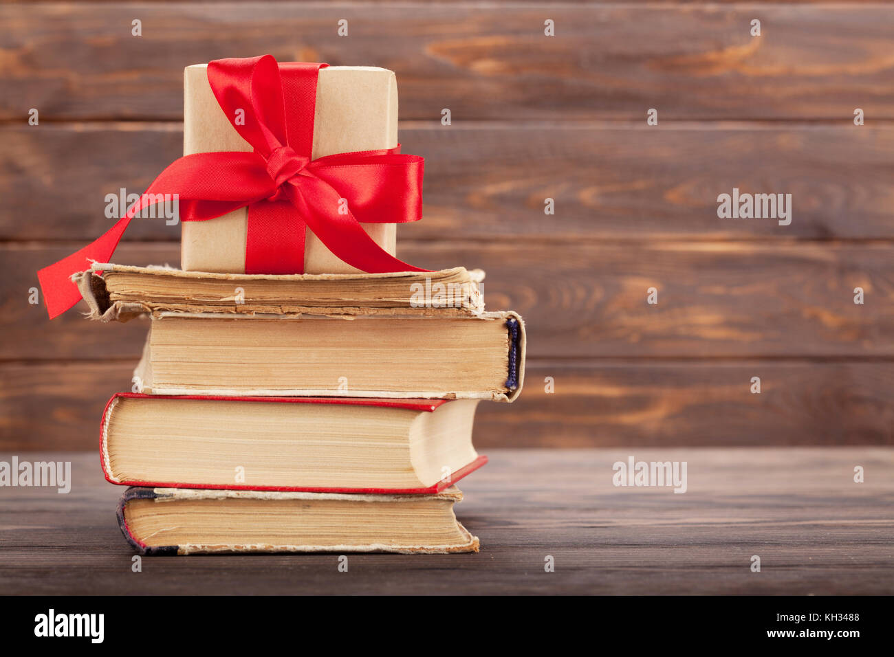 Christmas gift box in front of wooden wall with space for your ...