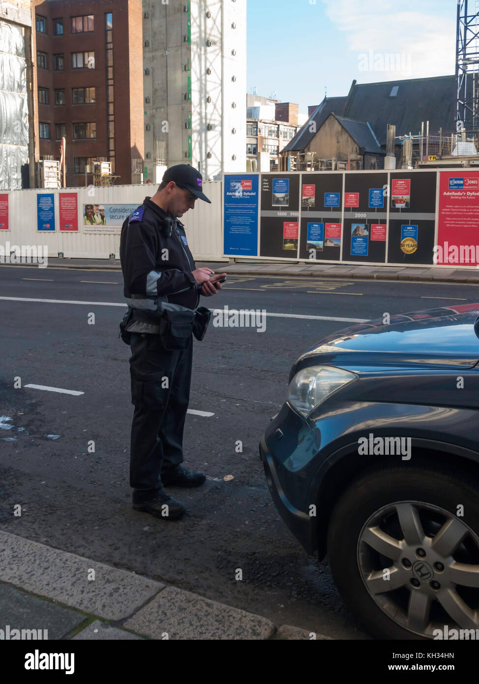 A Civil Enforcement Officer tasked to keep traffic flowing recording ...