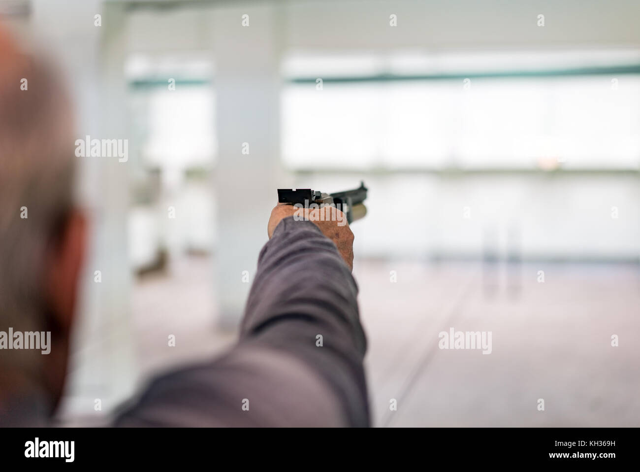 Aiming the target and Shooting with Pistol, Indoors Stock Photo - Alamy