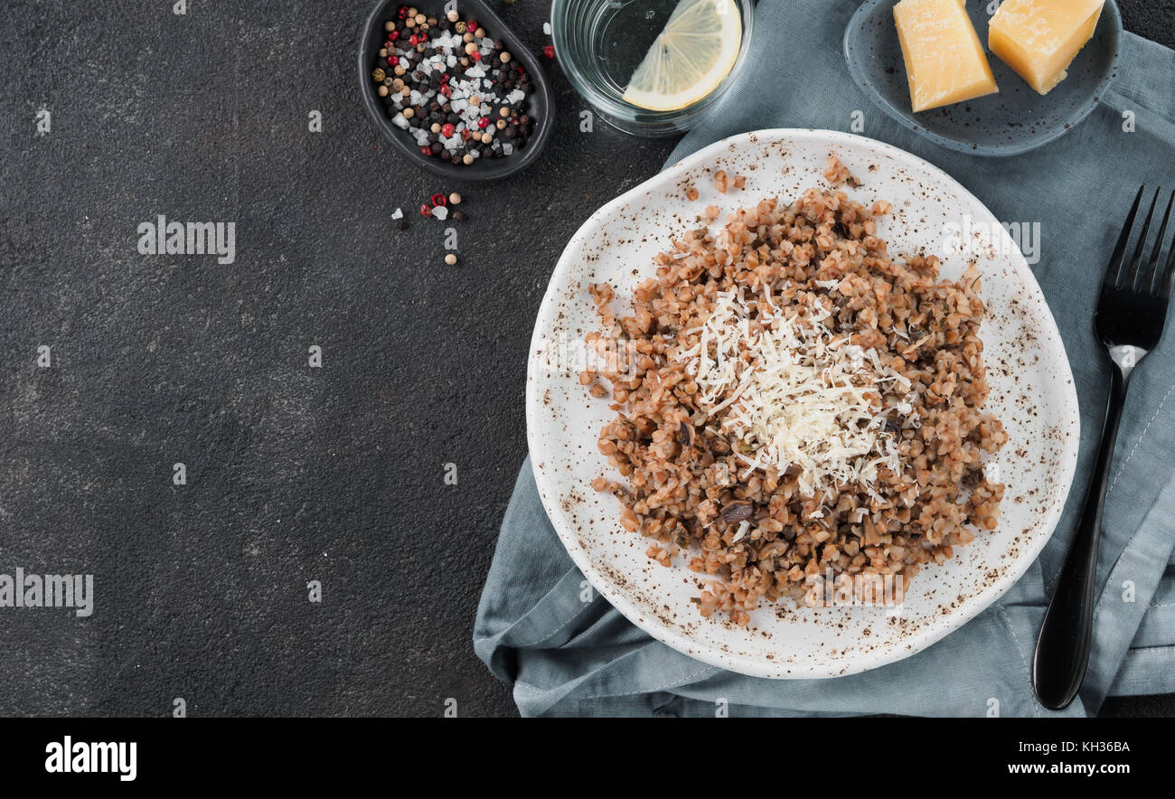 Buckwheat risotto with dried mushrooms served parmesan cheese in craft ...