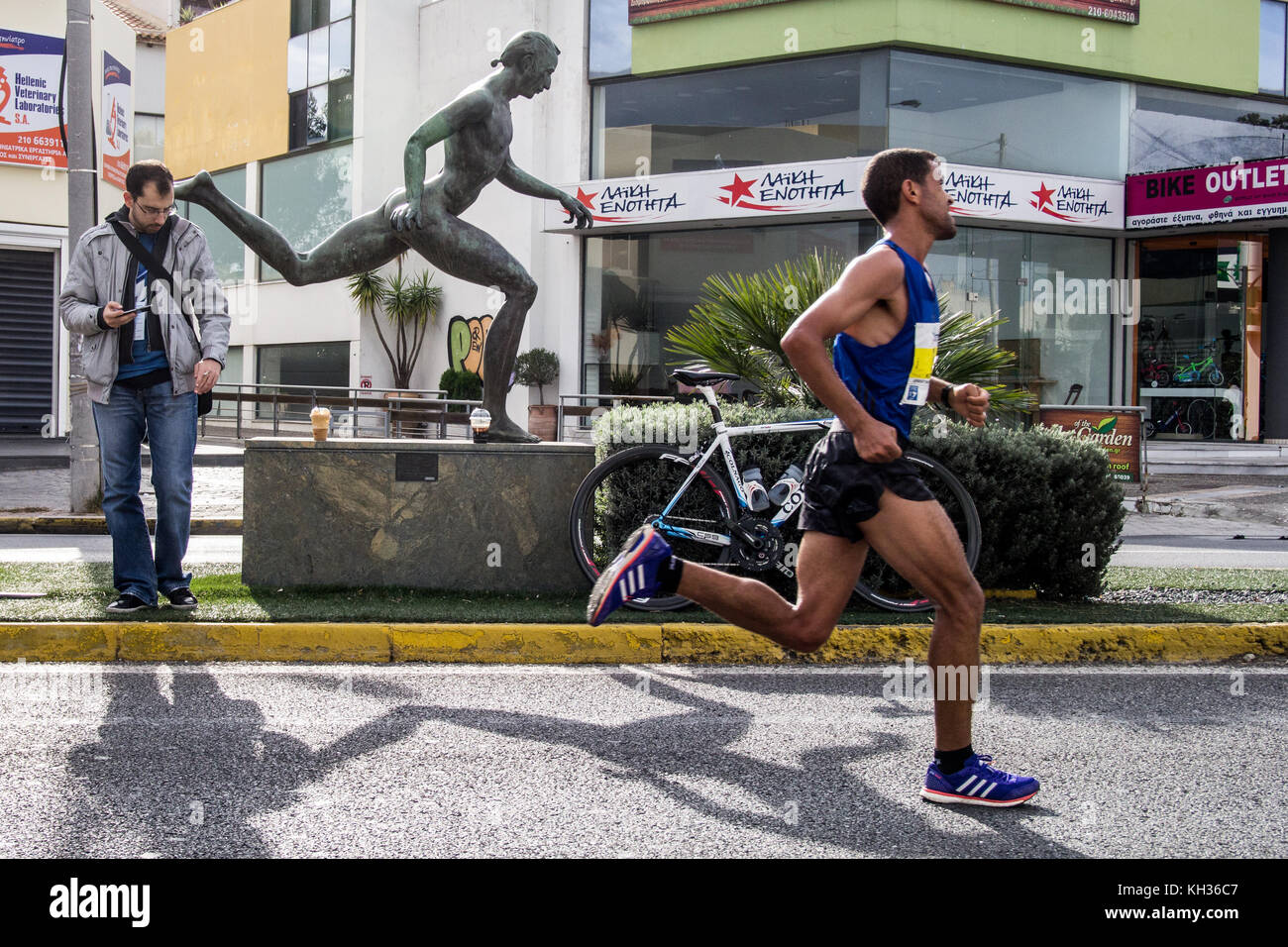 Athens, Greece. 12th Nov, 2017. An athlete passes the statue of ...