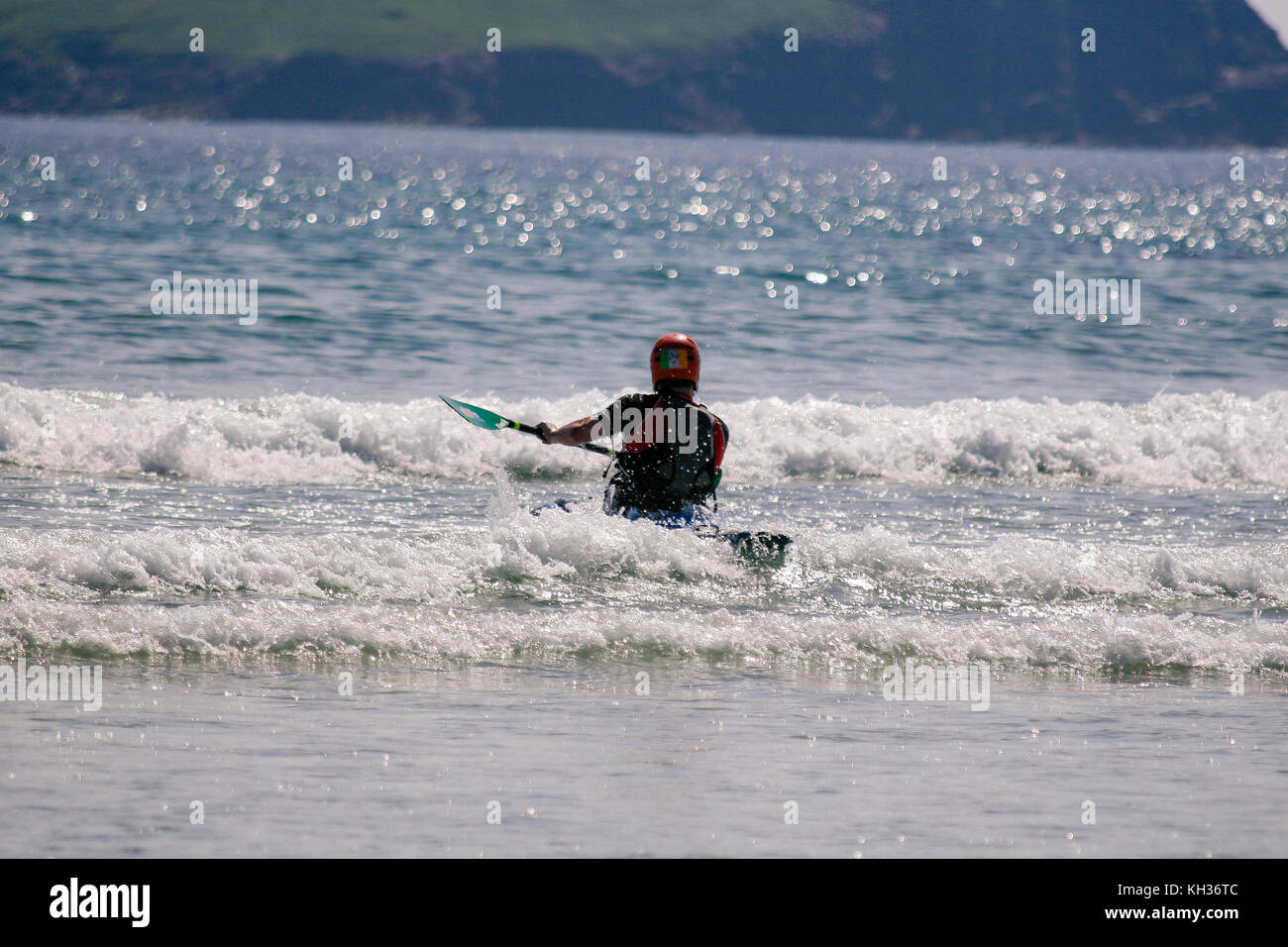Man sea kayaking on a sunny June summer day on the Keel Beach in Keel ...