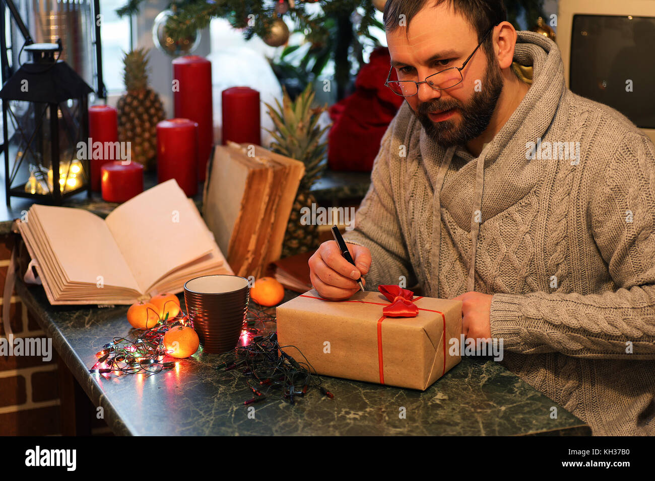 beard man writing christmas gifts on a table Stock Photo - Alamy
