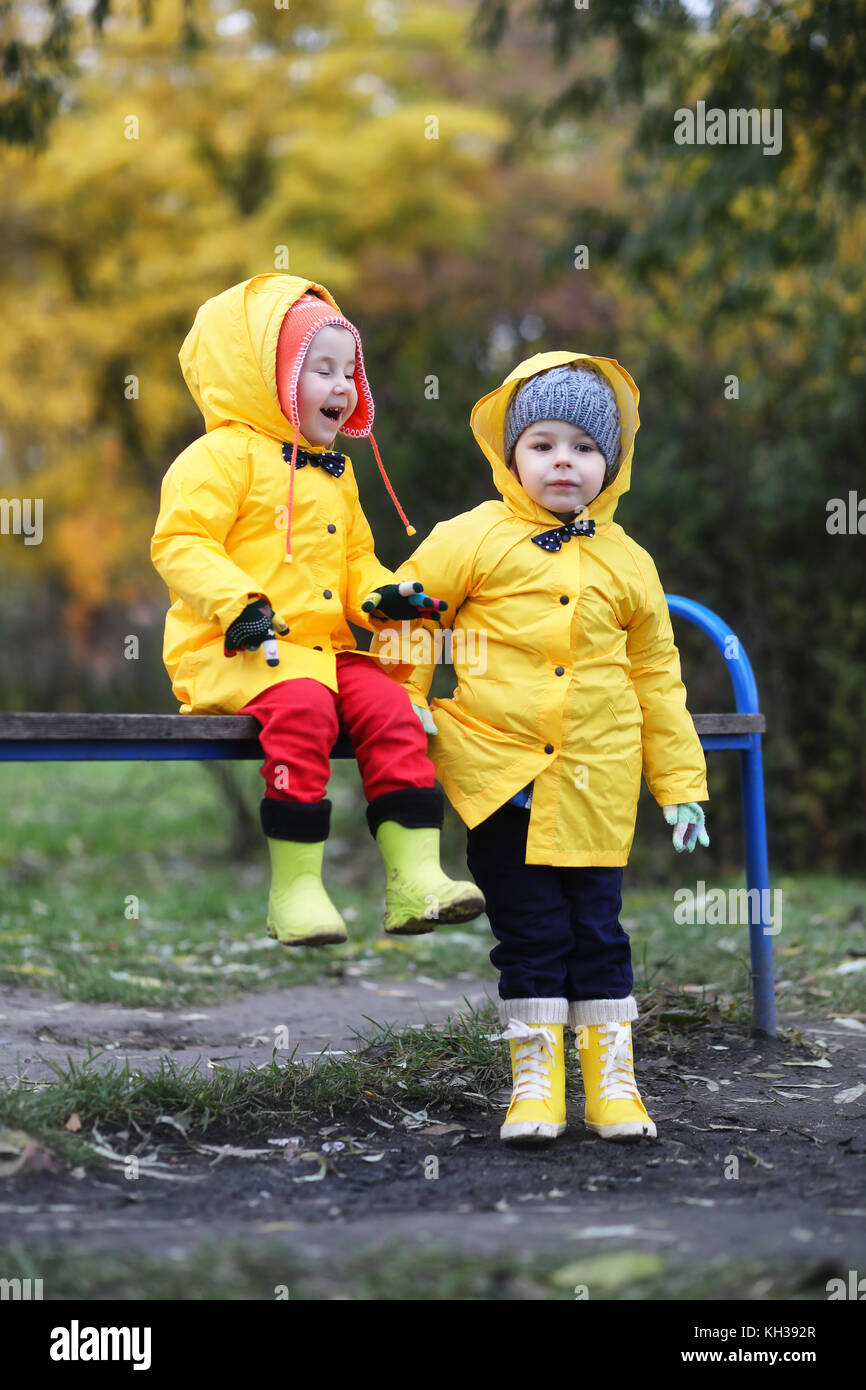 Children in the autumn park walk Stock Photo - Alamy