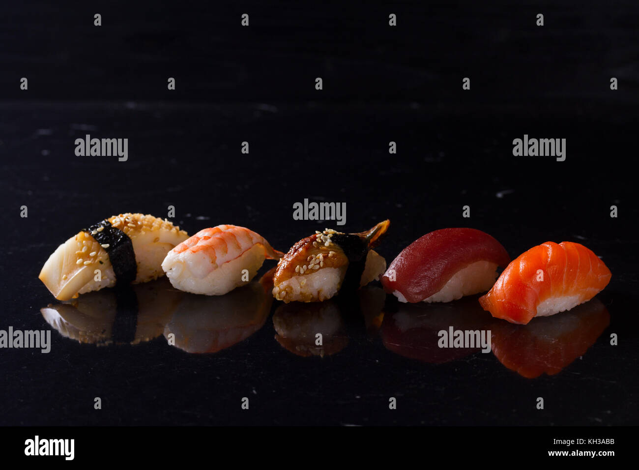 Row of Japanese sushi pieces on black background with copy space Stock ...