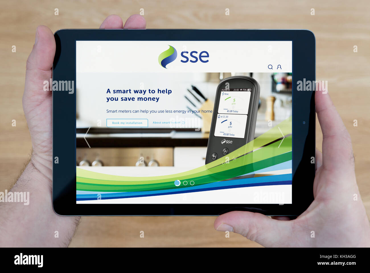 A man looks at the SSE website on his iPad tablet device, shot against ...