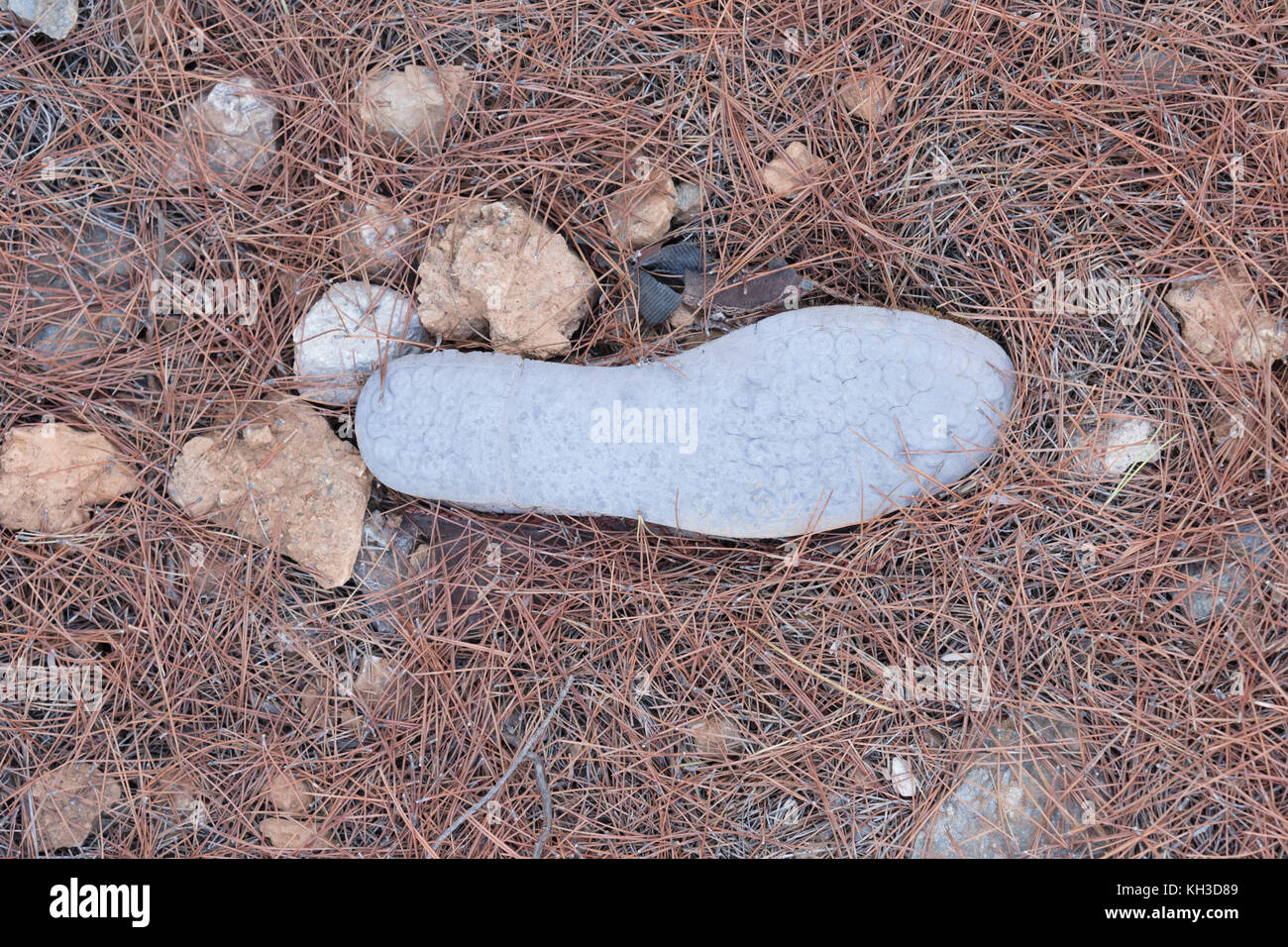 Pollution in Greece - Shoe left in nature Stock Photo - Alamy