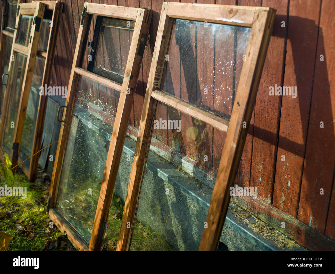 Abandoned windows next to the rustic wooden wall, daylight cropped ...