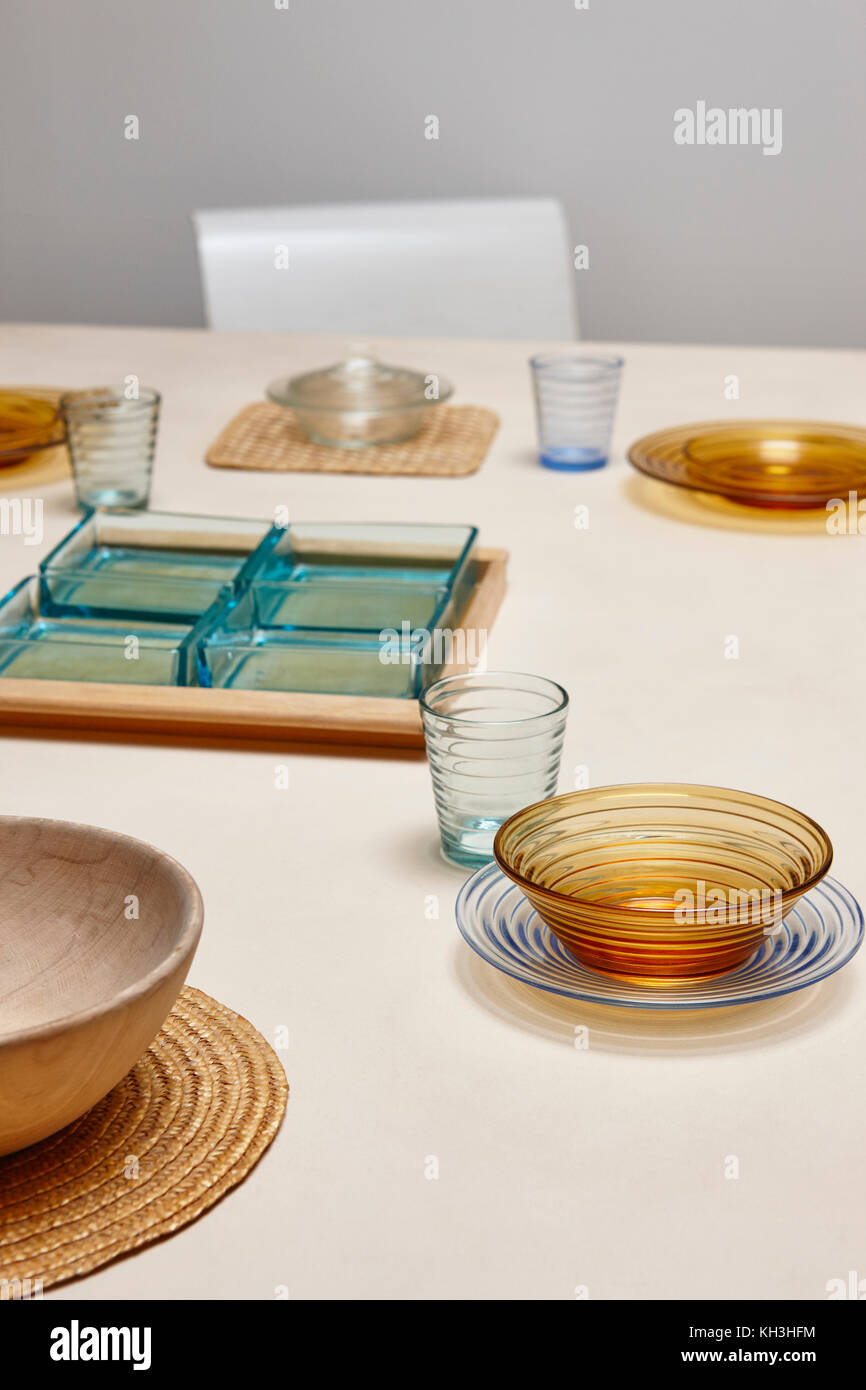 Elegant restaurant crystal tableware with colored dishes and glasses ...