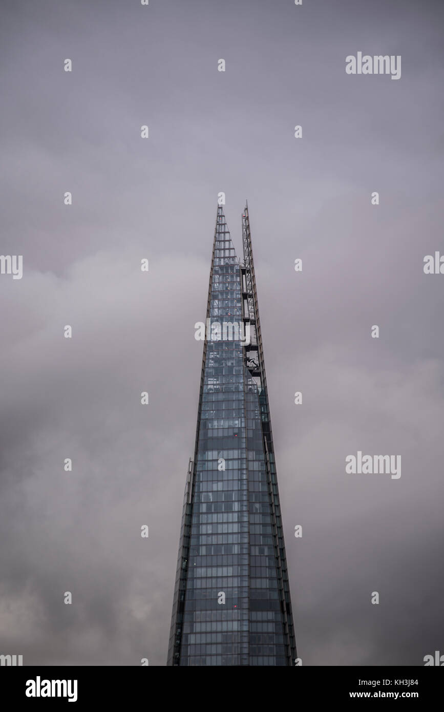 Top spire of The Shard on a dull cloudy day. Grim Stock Photo - Alamy