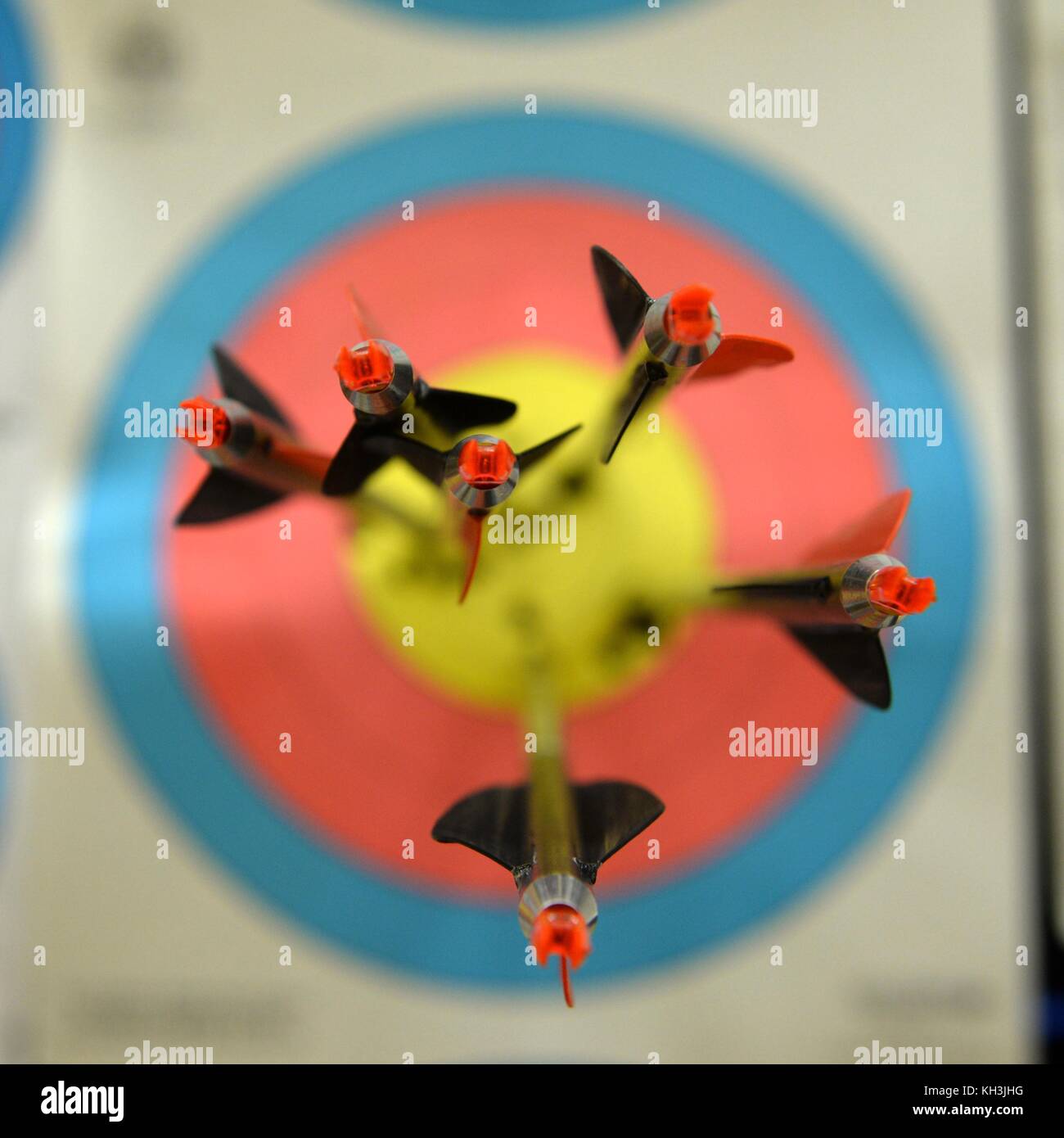 Six arrows hitting the gold on and archery target Stock Photo - Alamy
