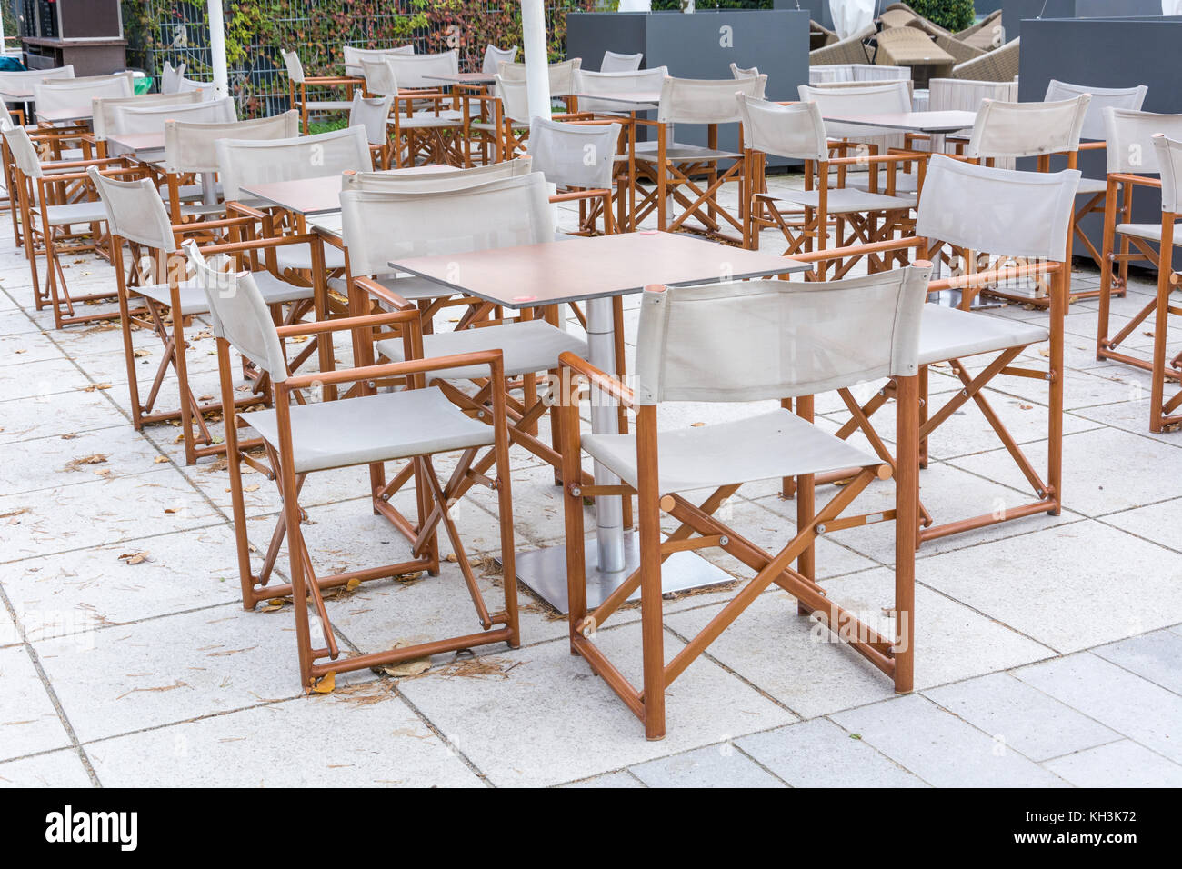 Several wooden beige linen chairs from a cafe Stock Photo - Alamy