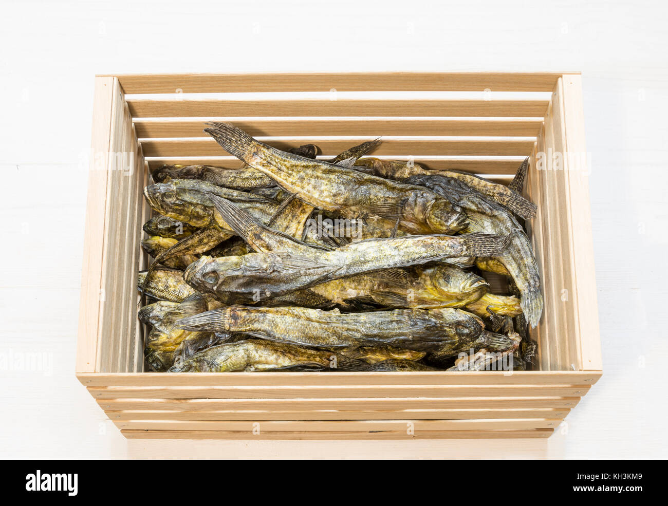 Dried Small fish in wooden box on white. Beer snack Stock Photo - Alamy