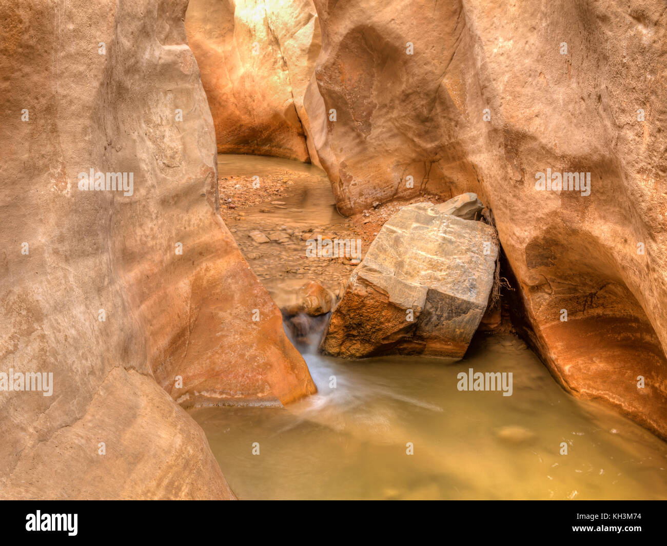 A boulder creates a small falls and pool in Willis Creek Slot Canyon in ...