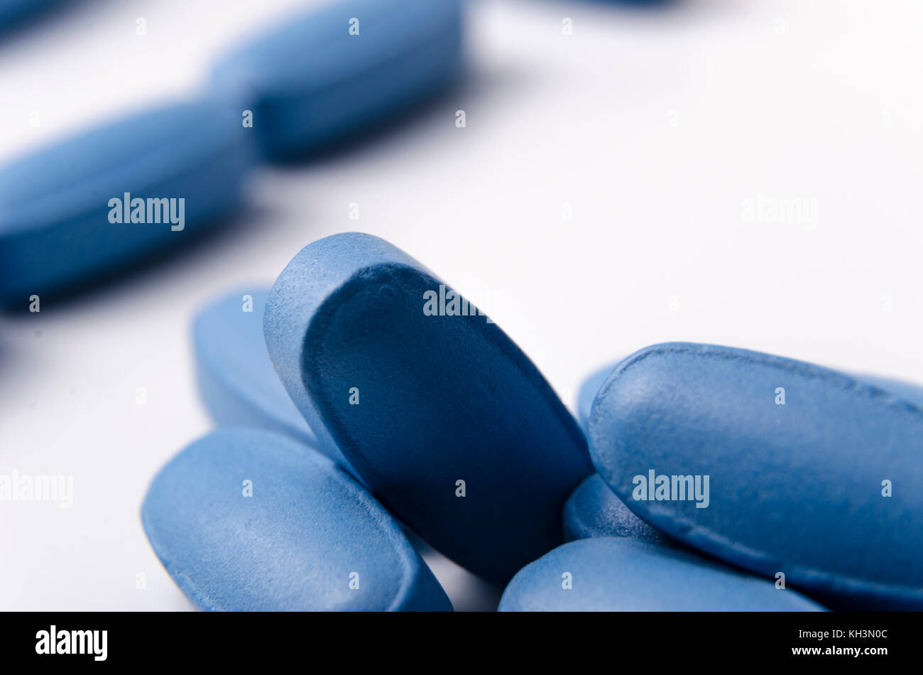 close up of blue pills or tablets over a white background Stock Photo ...