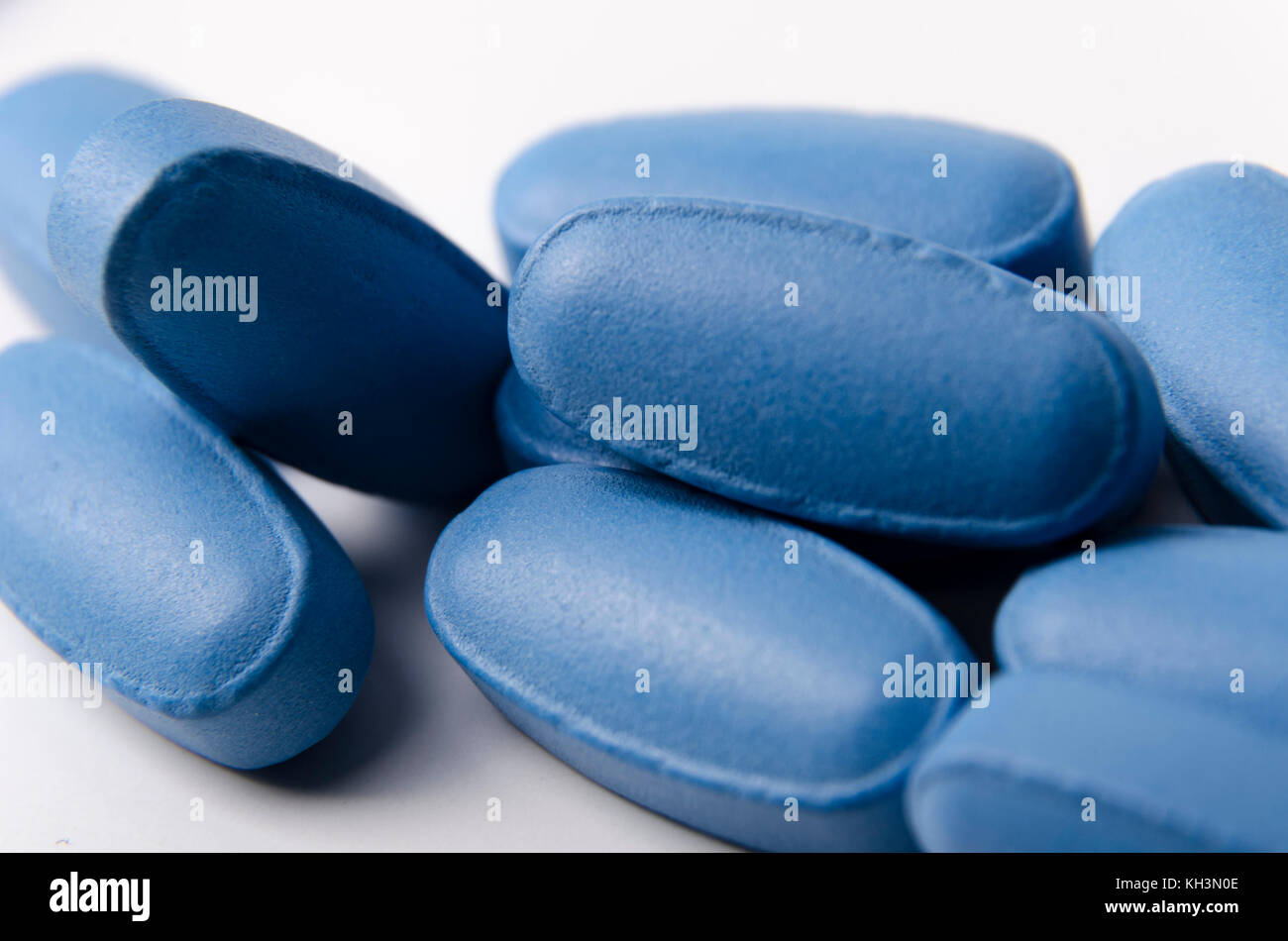 close up of blue pills or tablets over a white background Stock Photo ...
