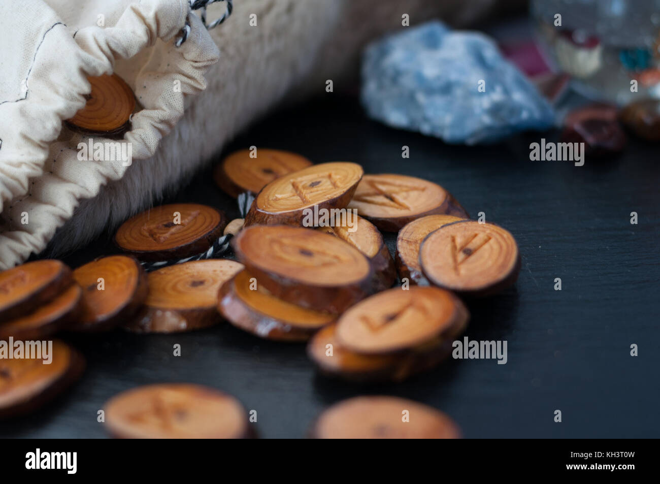 wood runes handmade fur are lying beside the crystal ball and semi ...