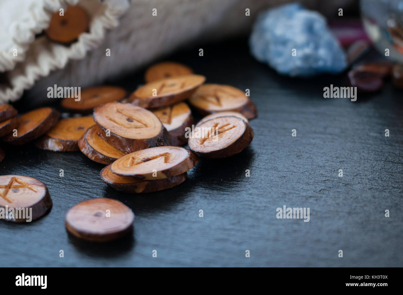 wood runes handmade fur are lying beside the crystal ball and semi ...
