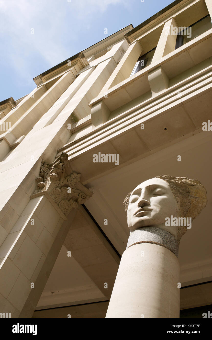 Contrast between classic stone pillars with statue heads and modern ...