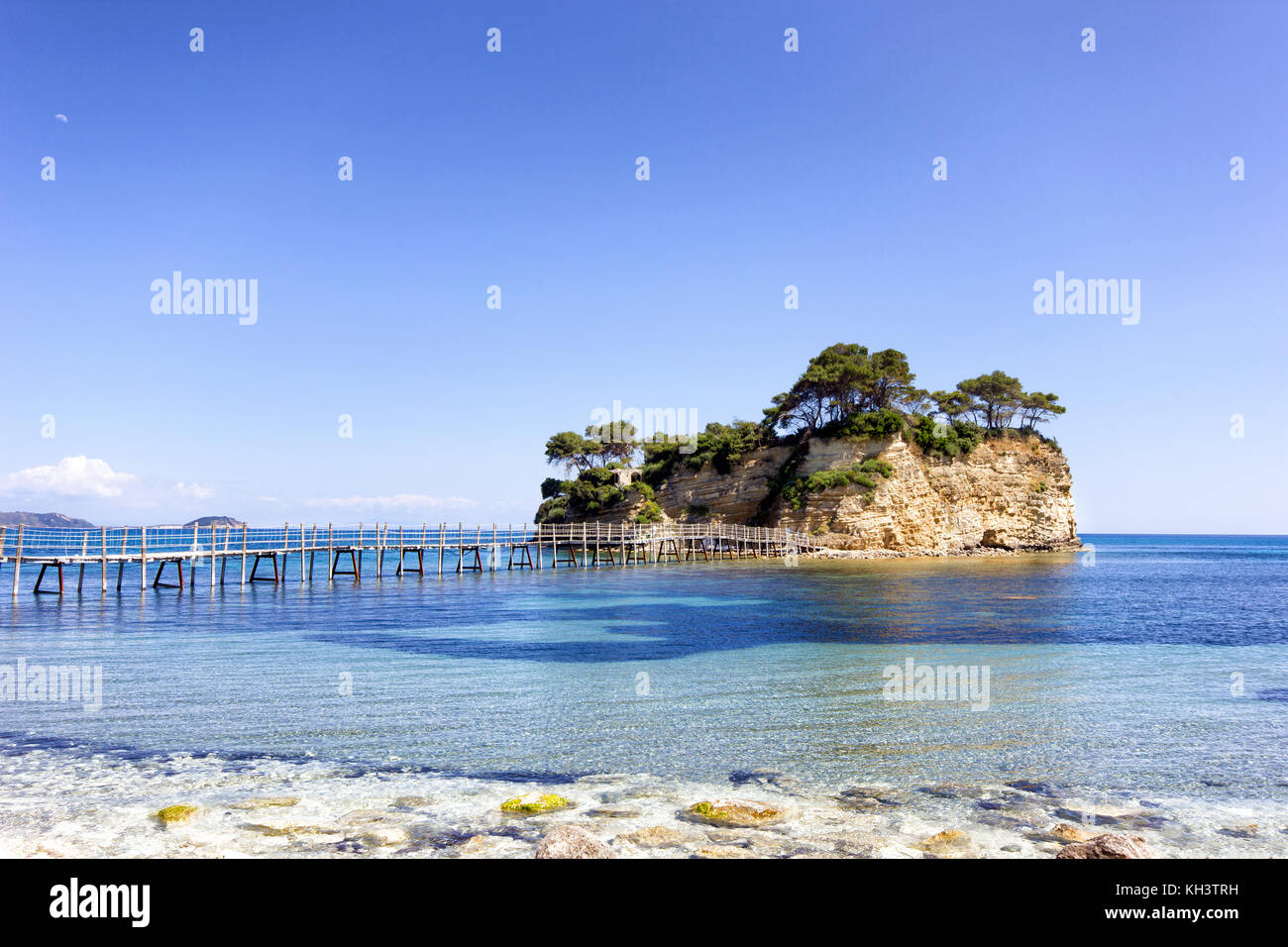 small island with wooden bridge crossing the shore in Zante,Greece ...